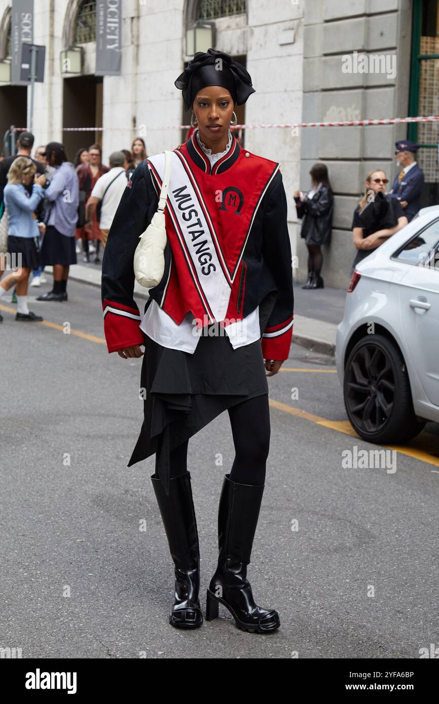 MILAN, ITALY - SEPTEMBER 19, 2024: Woman with red, black and white ...