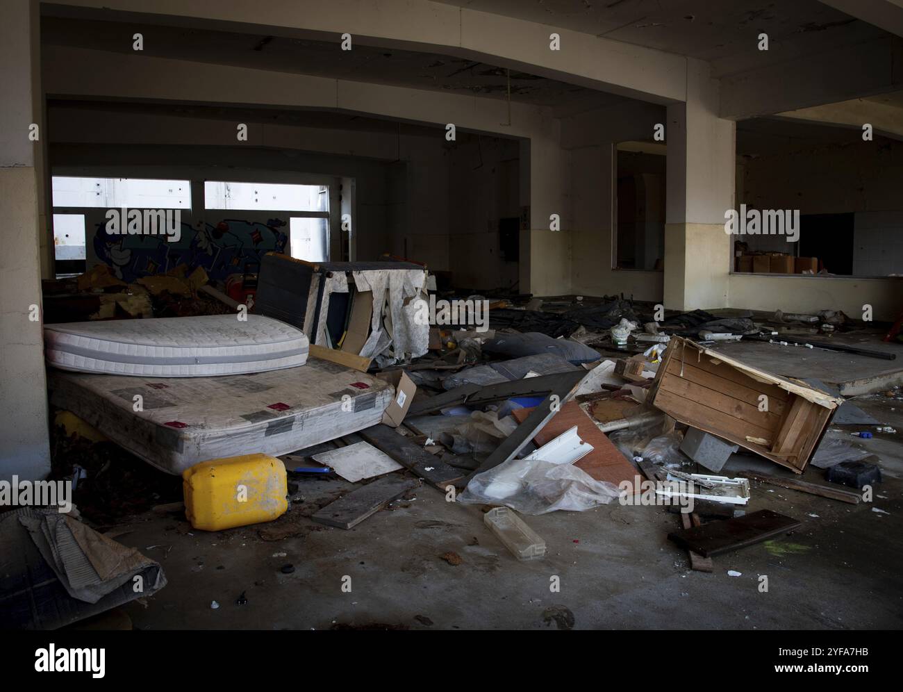 Interior of an old abandoned house kitchen with damaged furniture and a ...