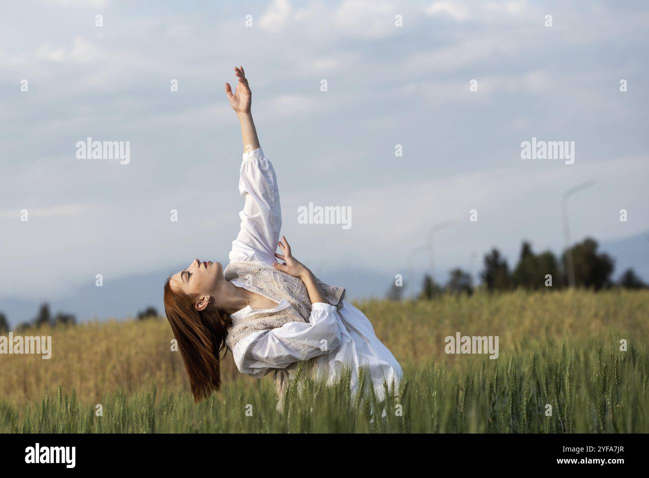 Young dancer woman dancing outdoors. Modern dance performance in the ...