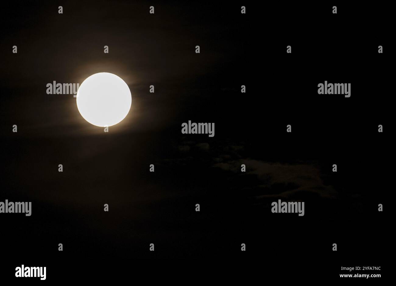 Super bright full moon and partially covered with dramatic black sky ...