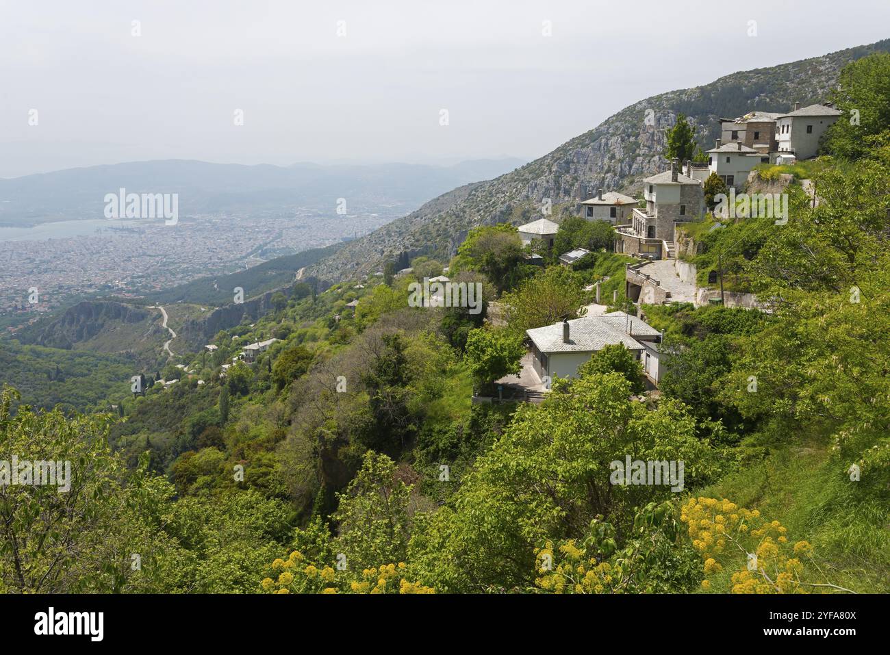 Mountain landscape with scattered houses on a green slope and a wide ...
