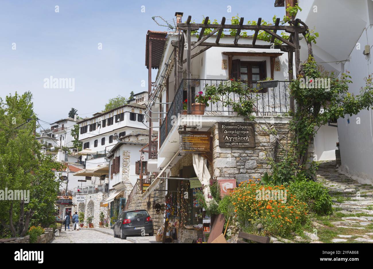 Picturesque view of a traditional Greek street with flowers and ...