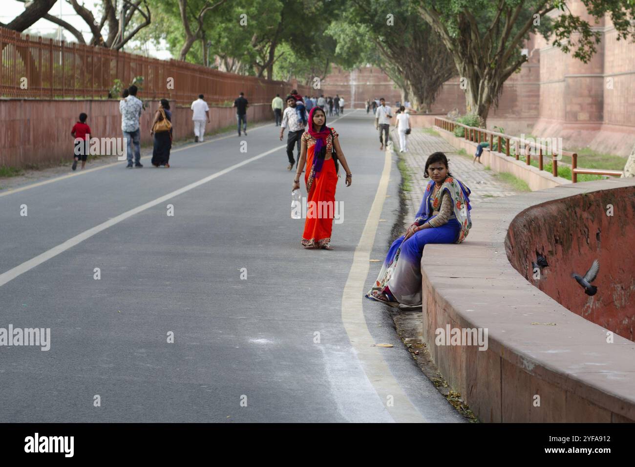 Asian people with colorful traditional costumes walking outside the ...