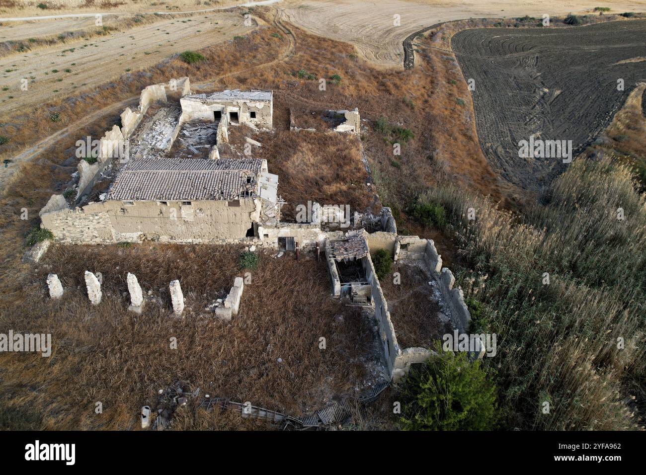 Drone aerial top view scenery of an abandoned deserted farmhouse outdoor. Collapsing places ...