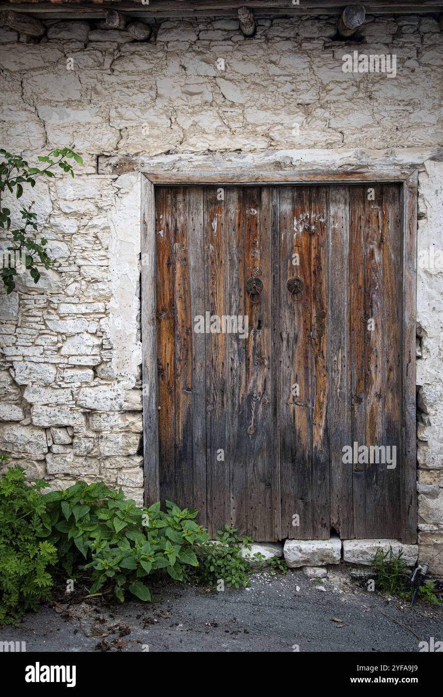 Entrance gate of an abandoned house with a brown closed traditional ...