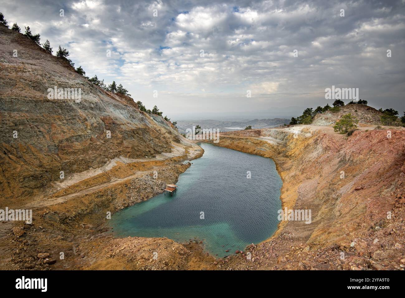 Blue lake and carved mountain of Alestos abandoned mine in cyprus ...