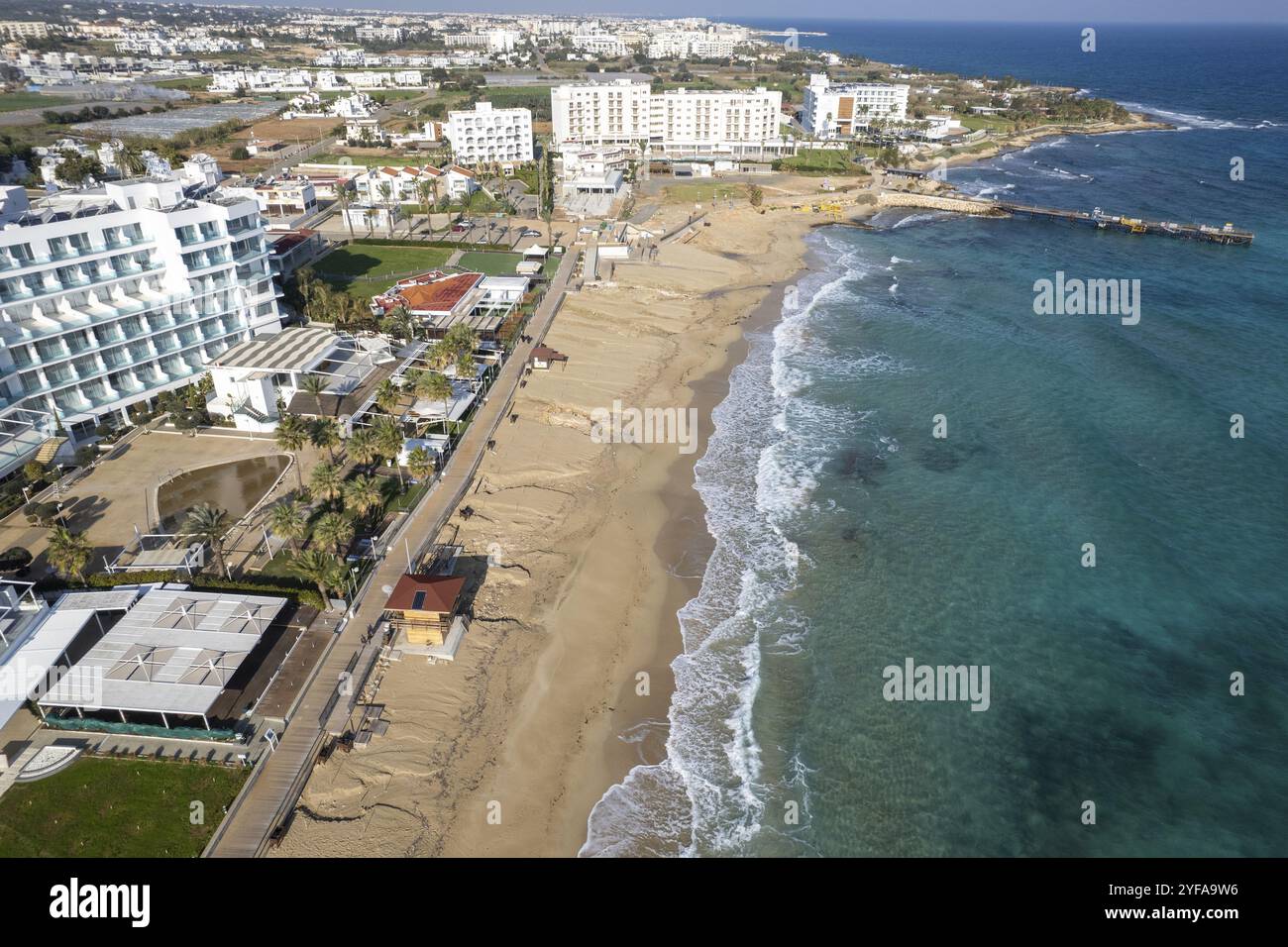 Aerial view of ocean waves breaking on a sandy beach. Beach erosion ...