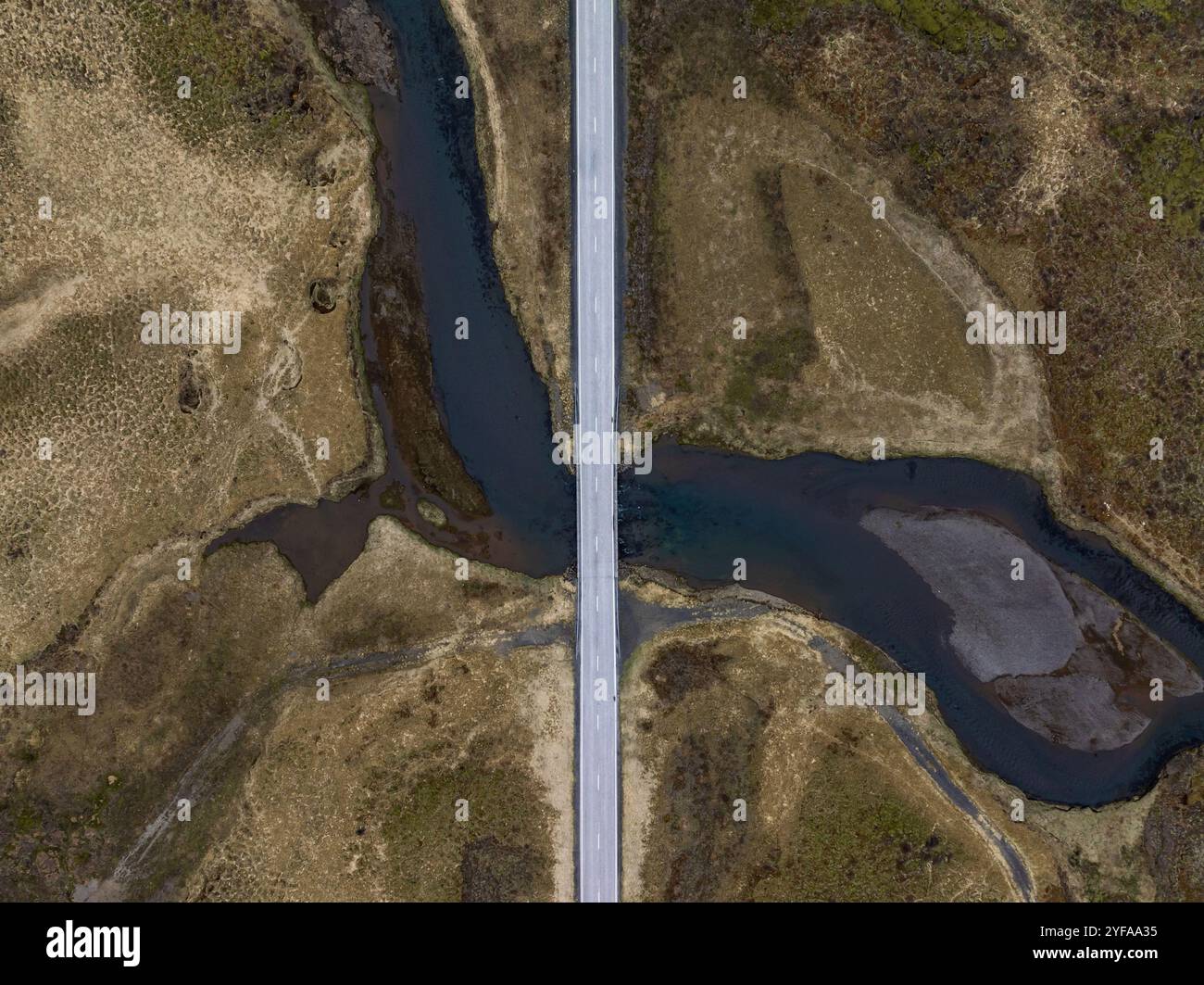 Aerial view of an Icelandic landscape with a long straight road ...