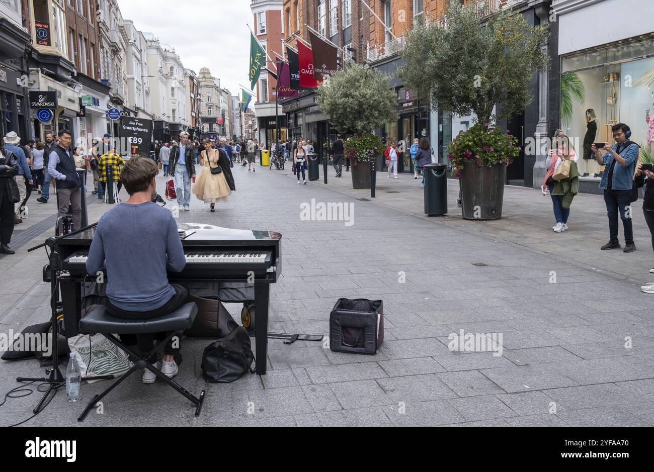 Dublin, Ireland, July 21 2022: Young pianist street musician playing ...