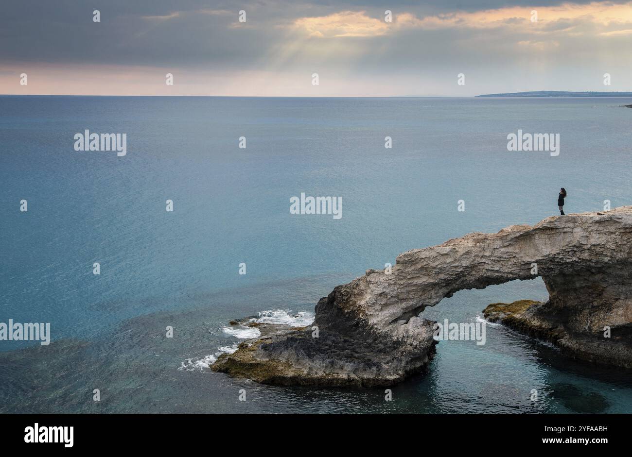 Woman standing at lovers bridge enjoying the scenery of the sea at ...
