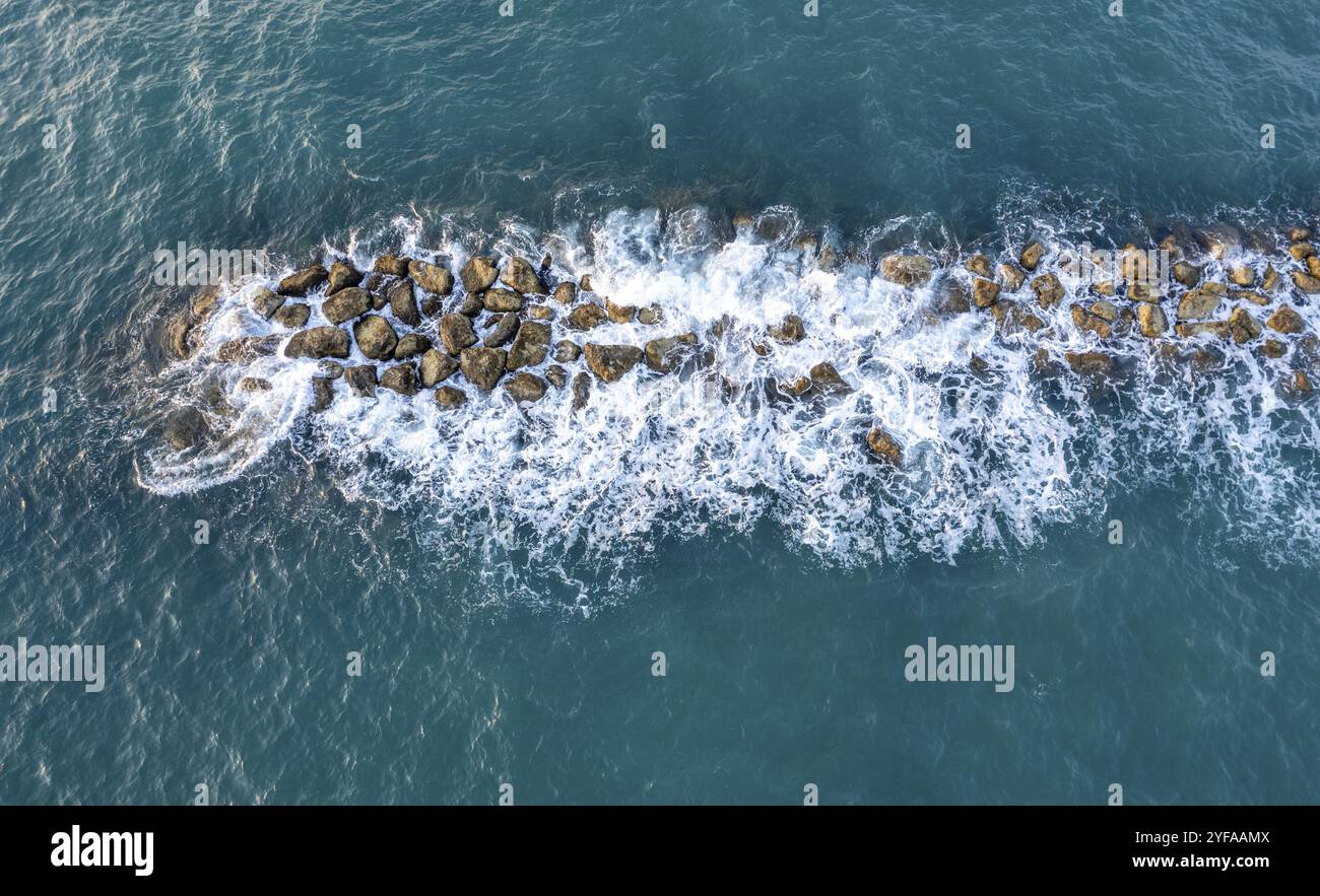 Aerial view from a flying drone of blue sea water and break water. Sea ...
