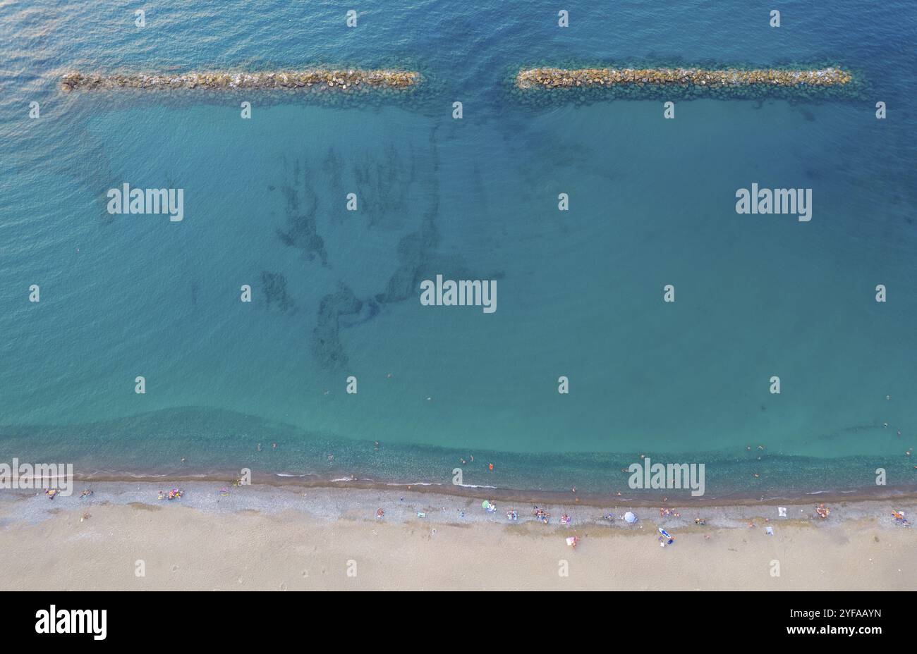 Aerial view from flying drone of people resting on the beach in Paphos ...