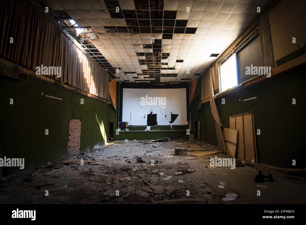 Abandoned and damaged interior of a stage theatre with bright light ...