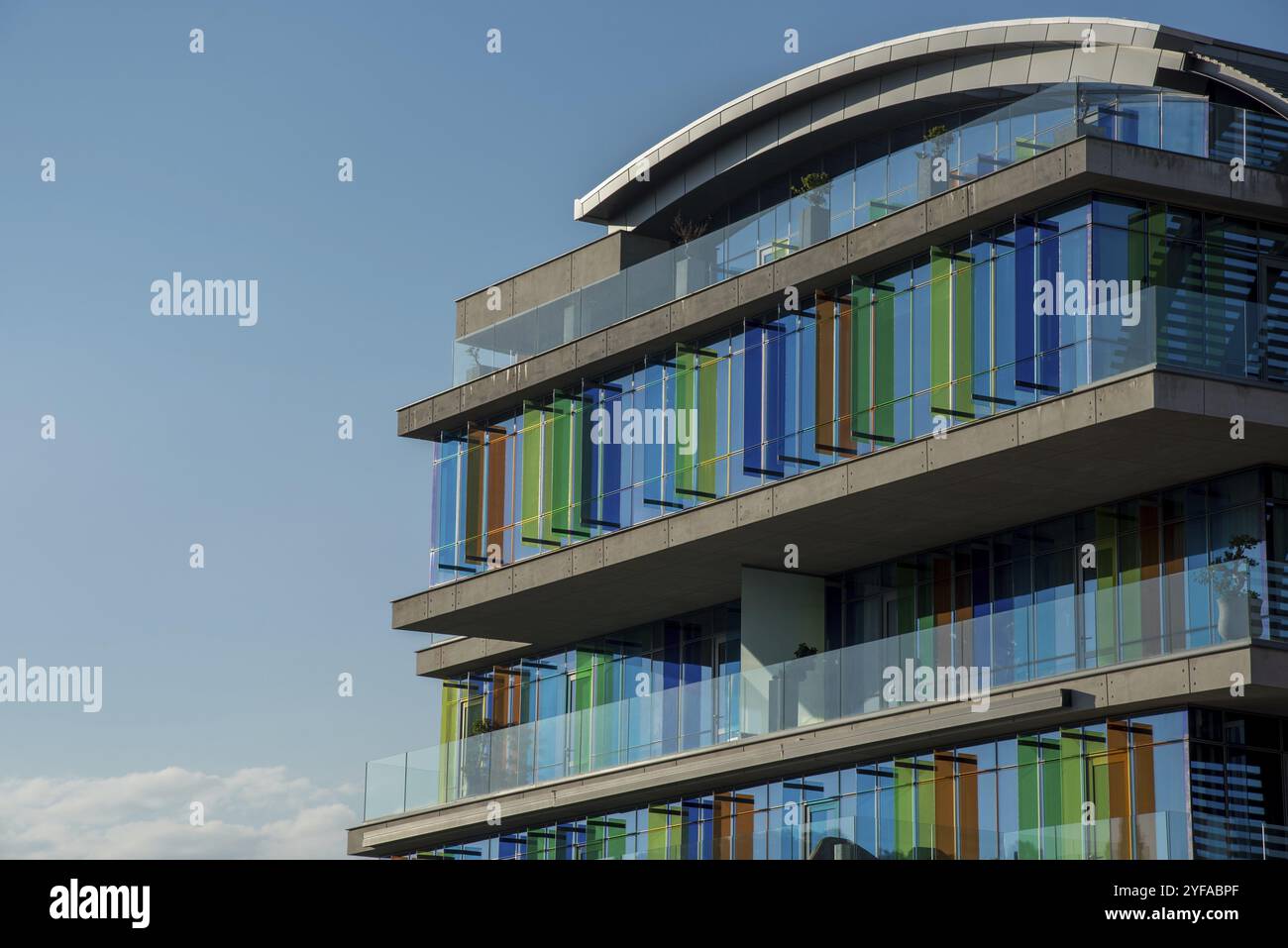 Exterior view of a Modern futuristic building with colourful glass wall ...
