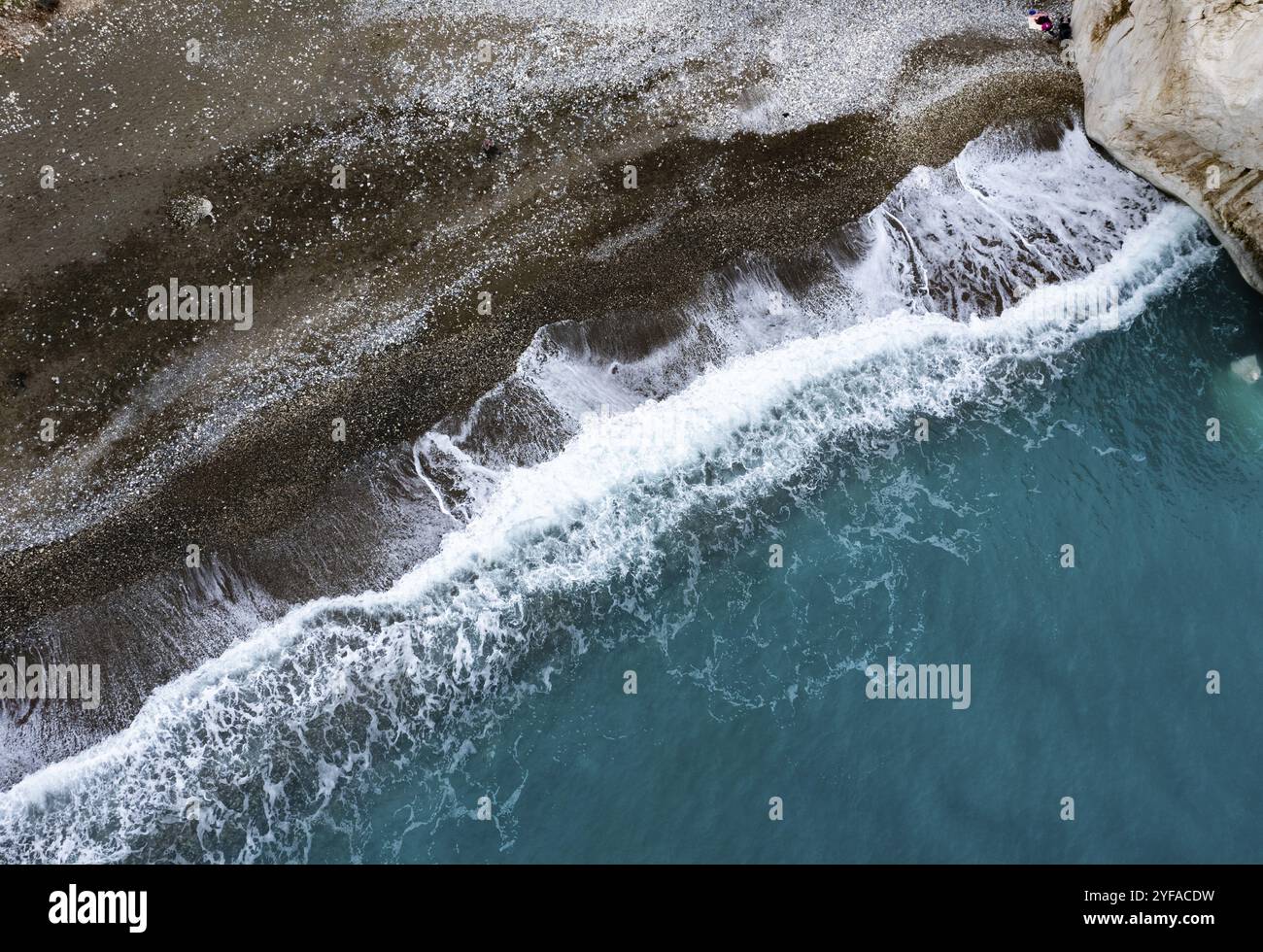 Drone aerial of rocky coast with sea waves hitting the shore. Seascape ...