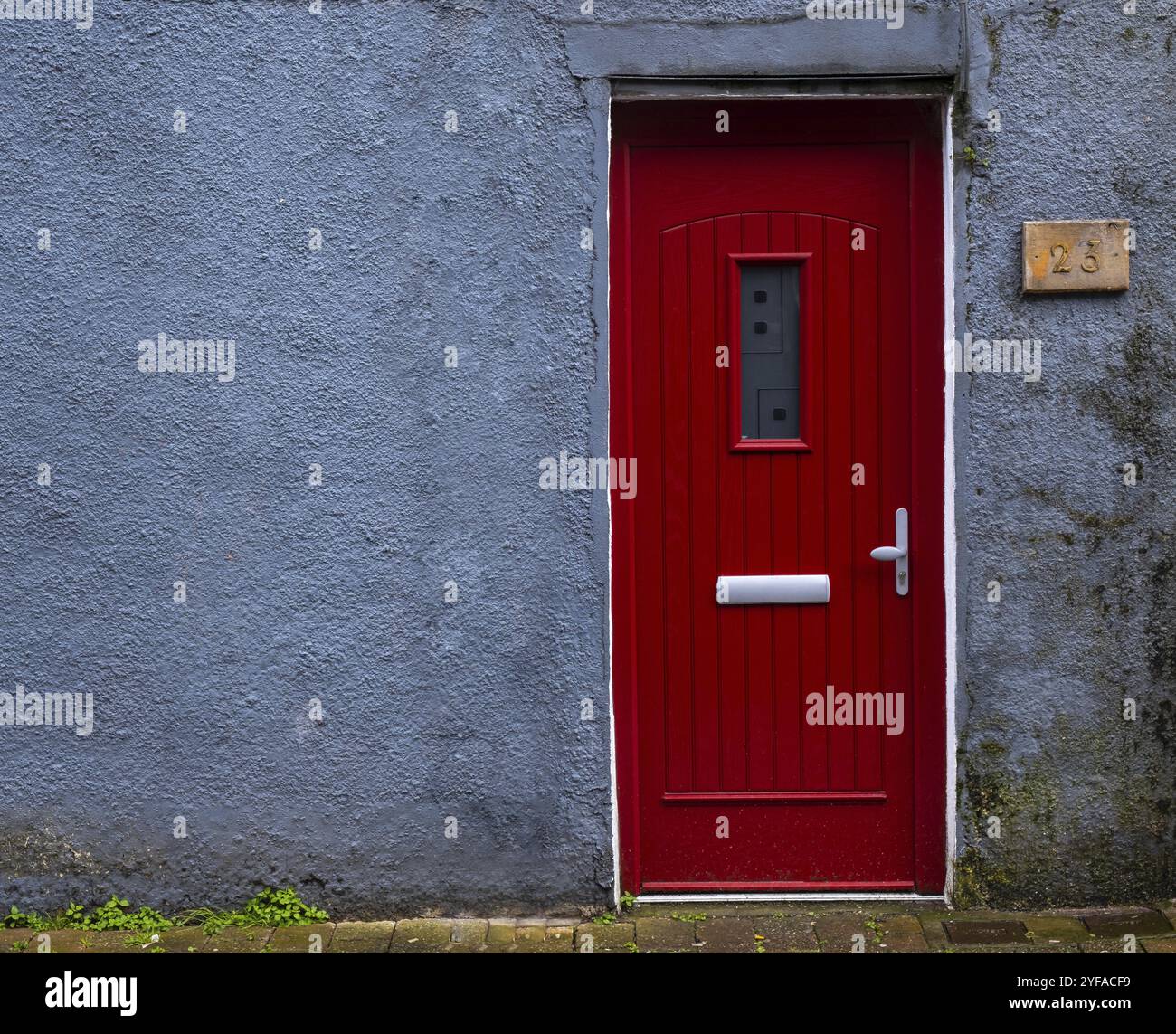 Traditional british house facade front entrance with red closed door ...