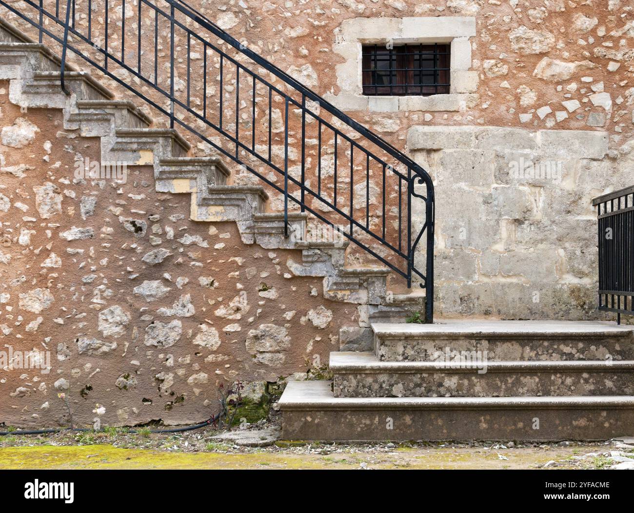 Metallic staircase leading to the roof and details of a simple brown ...