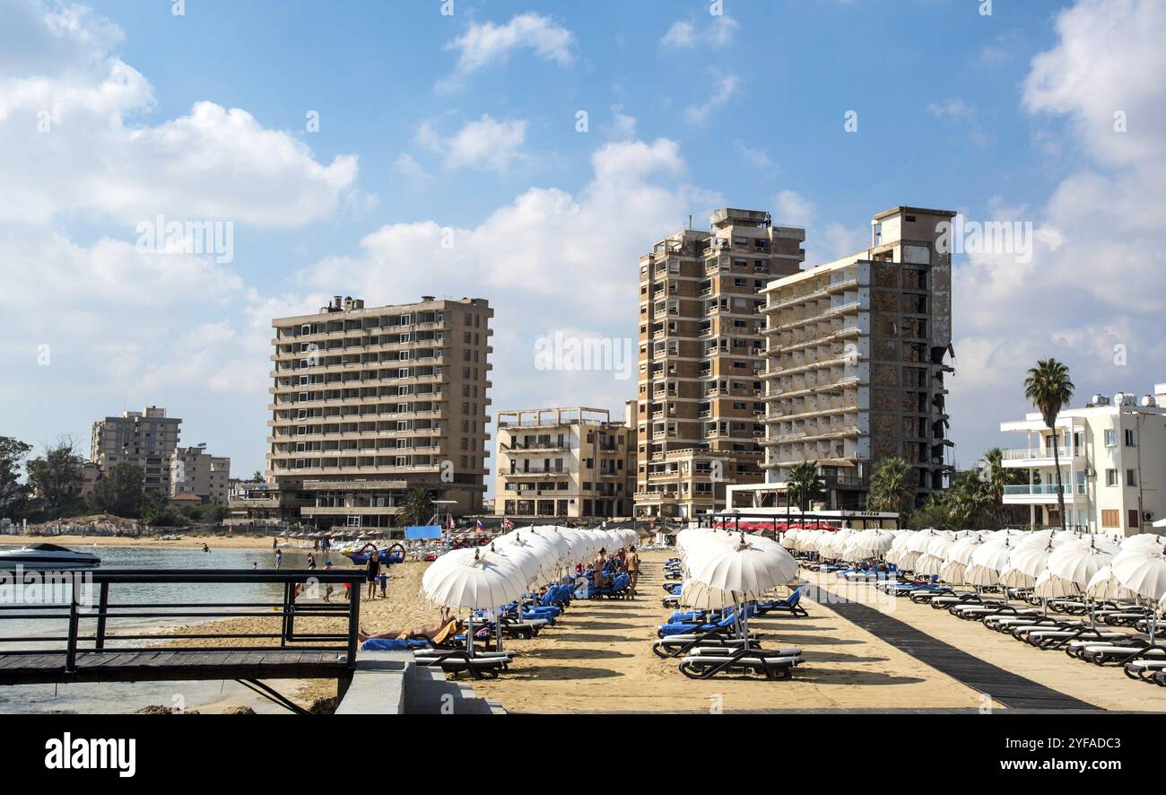 Palm Beach with beach umbrellas and tourists and the abandoned hotels ...