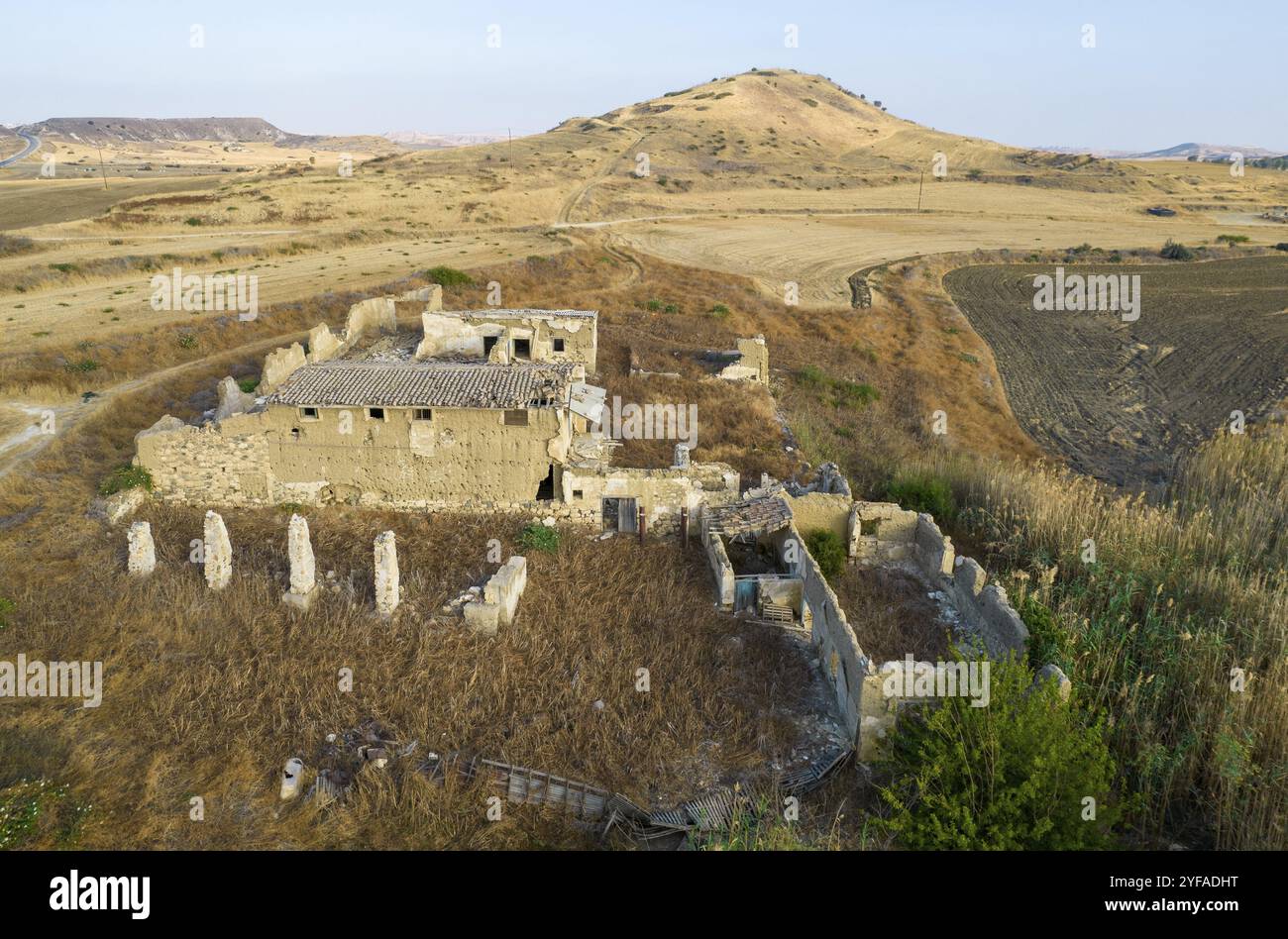 Aerial view of abandoned and collapsing animal farm building in the ...