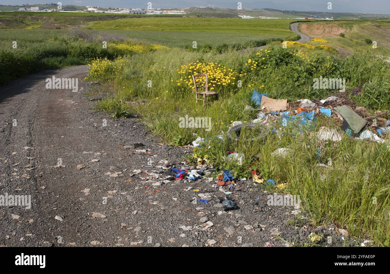 Trash in a beautiful spring countryside creating environmental ...