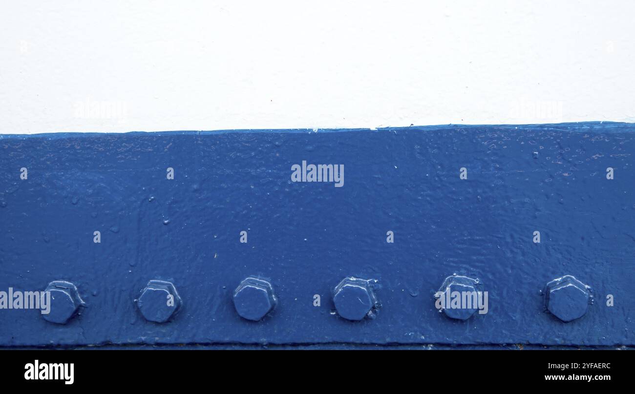 Blue and white abstract background with heavy duty screws connecting ...