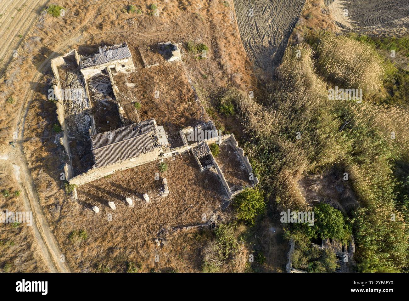 Aerial view of abandoned and collapsing animal farm building in the ...