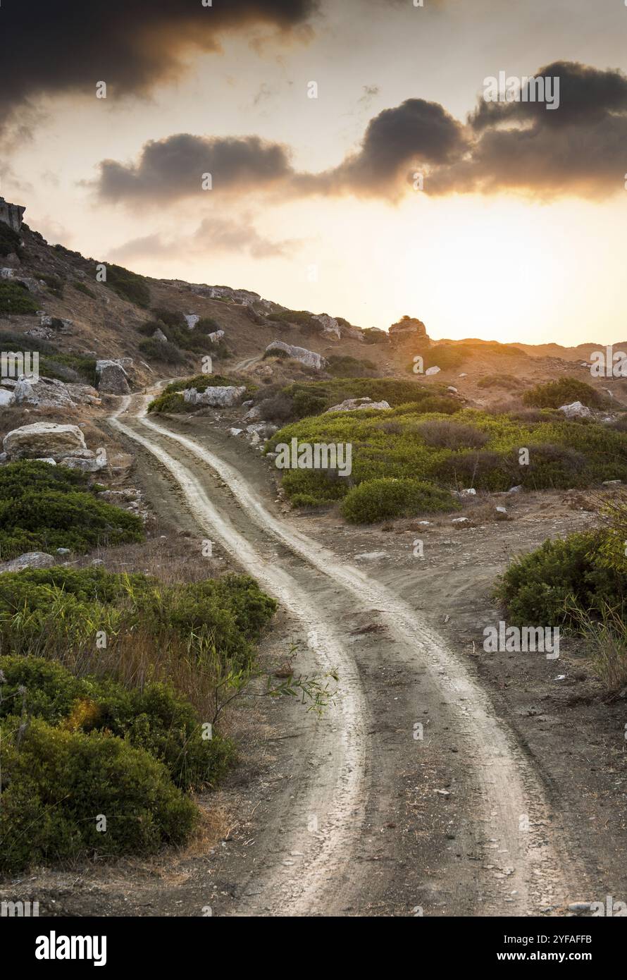 Single lane curved rural country road crossing through the hill during ...