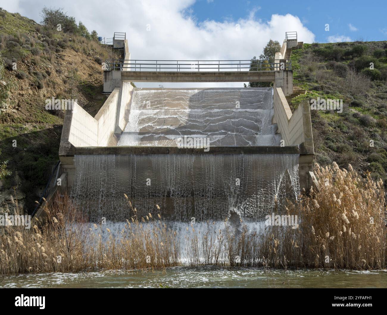 Overflow of the dam after heavy rain. Water reservoir flowing in a ...