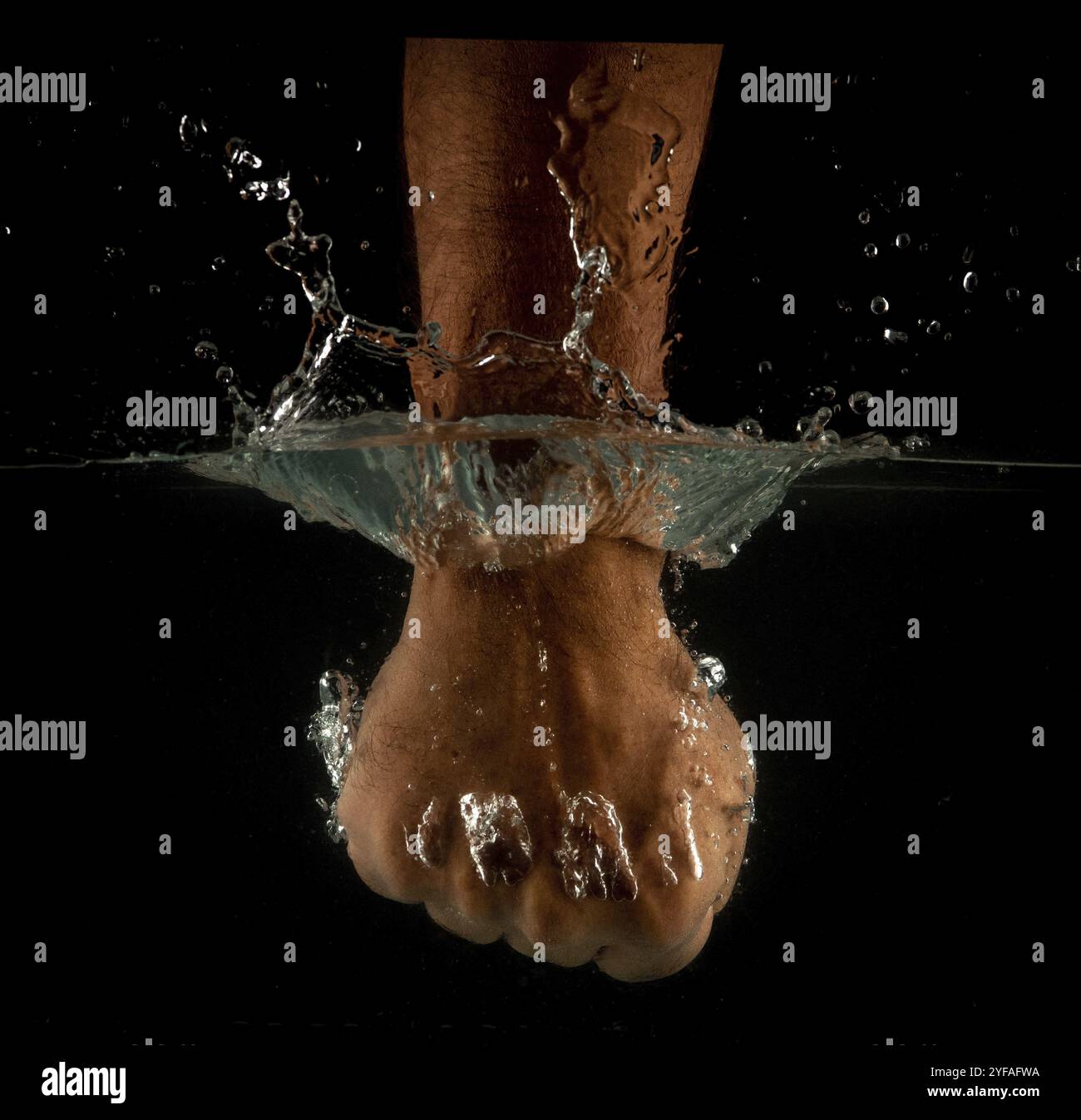 Angry mans fist punching water. Human power force in water Stock Photo ...