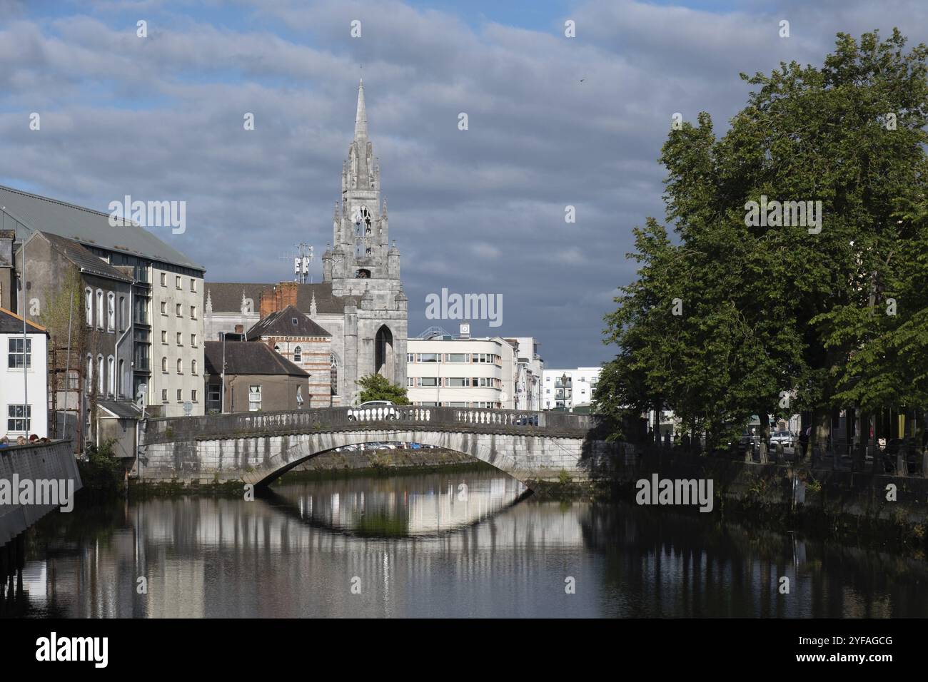 Urban cityscape of cork city with holy trinity church and lee river ...