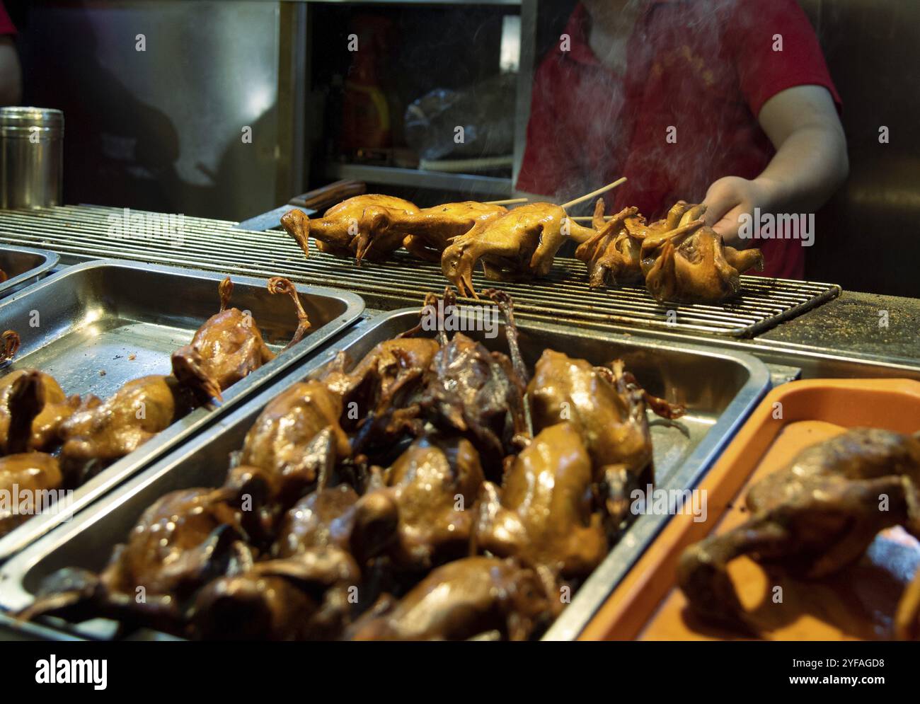 Chinese chef cooking traditional on the snack street in Beijing China ...