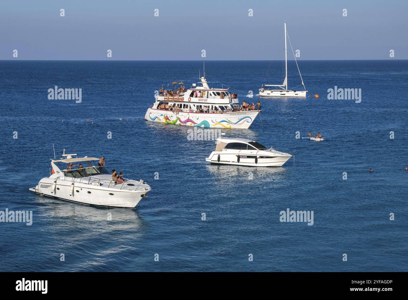 Tourist yachts with people sailing in the sea. Summer holidays in the ...