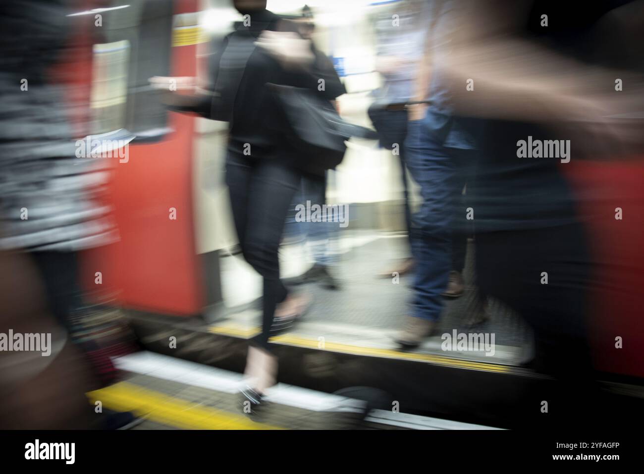 Random passengers people at the underground tube station with moving ...