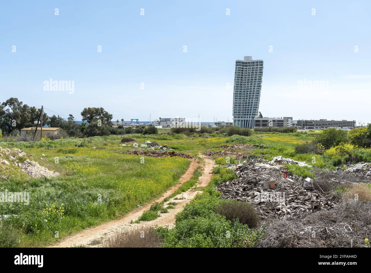 Modern skyscraper and junk yard of construction debris outside in the ...