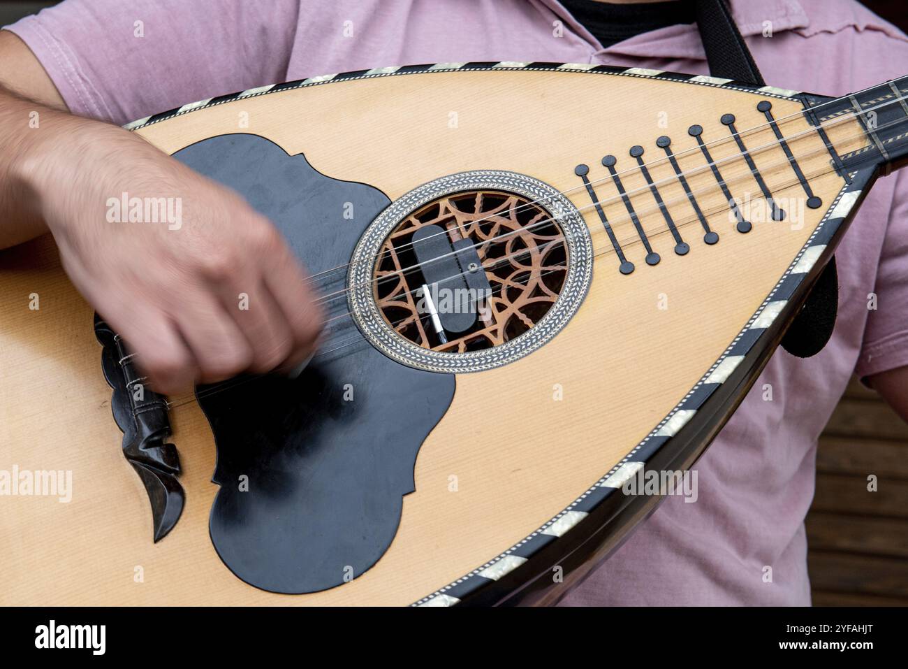 Unrecognised musician playing a traditional song with the laouto, lute ...
