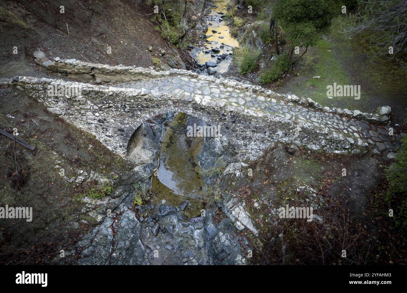 Aerial drone photograph of a medieval stoned bridge with water flowing ...