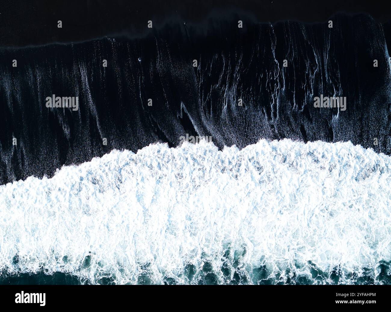 Aerial view of waves crashing on the black sand beach in Iceland, a ...
