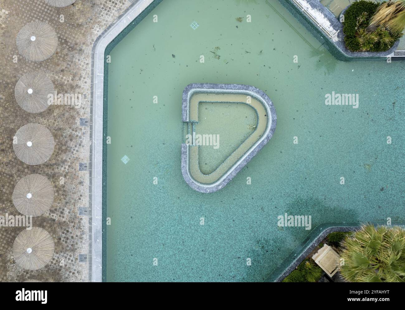 Drone aerial of empty abandoned hotel swimming pool. Dirty water ...