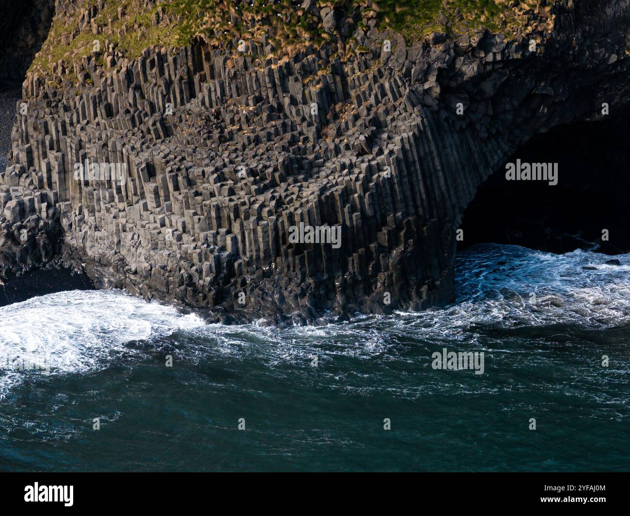 Aerial view of basalt columns and crashing waves at Reynisfjara black sand beach, Iceland Stock ...