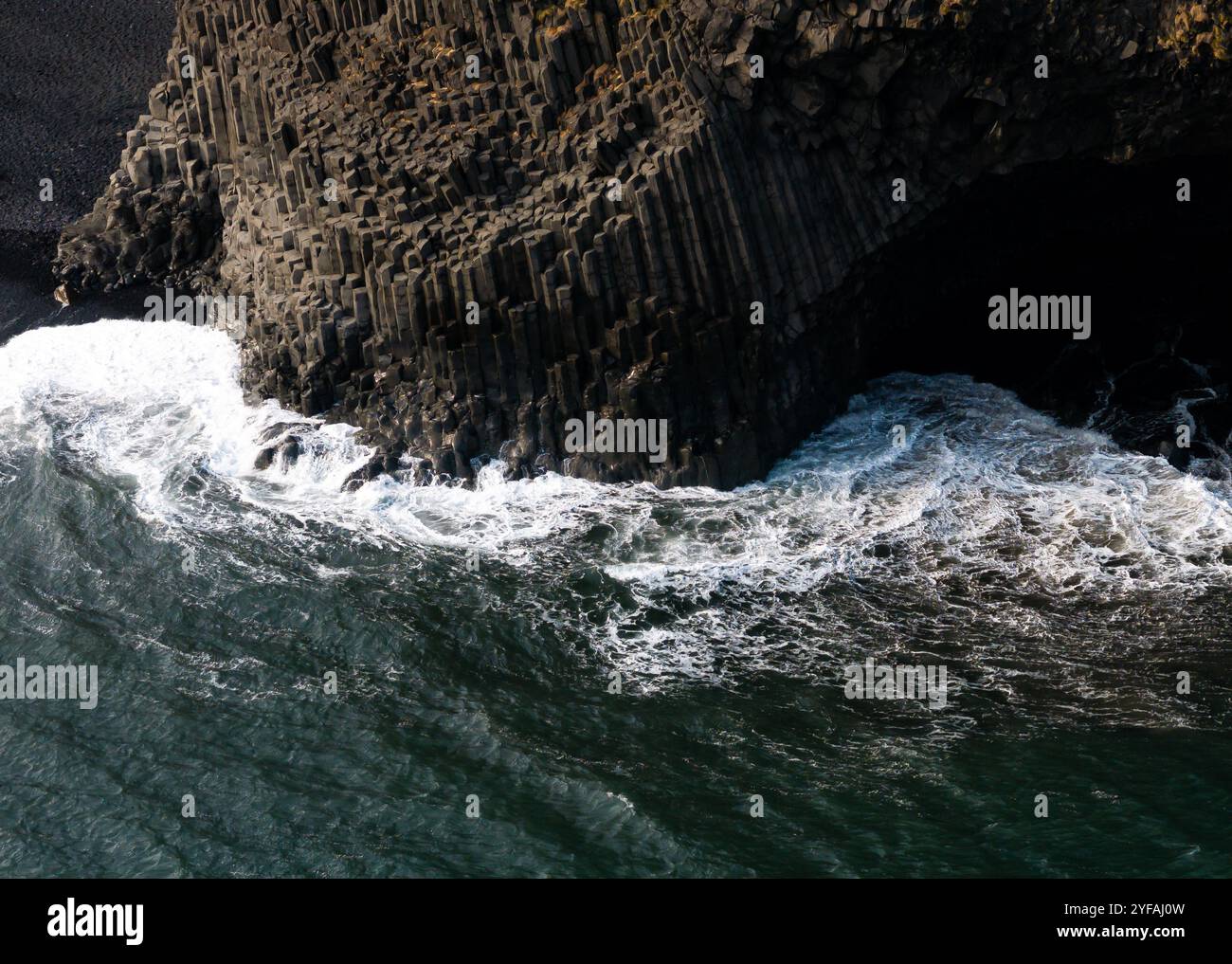Aerial view of basalt columns and crashing waves at Reynisfjara black sand beach, Iceland Stock ...