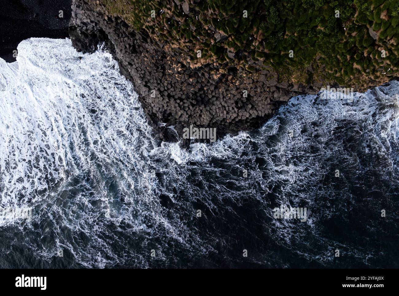 Aerial view of basalt columns and crashing waves at Reynisfjara black ...
