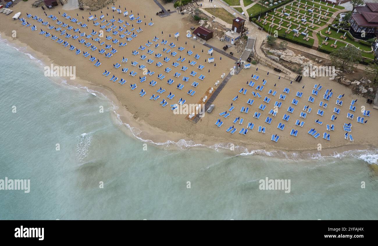 Drone aerial of beach chairs in a tropical sandy beach. Summer holidays ...