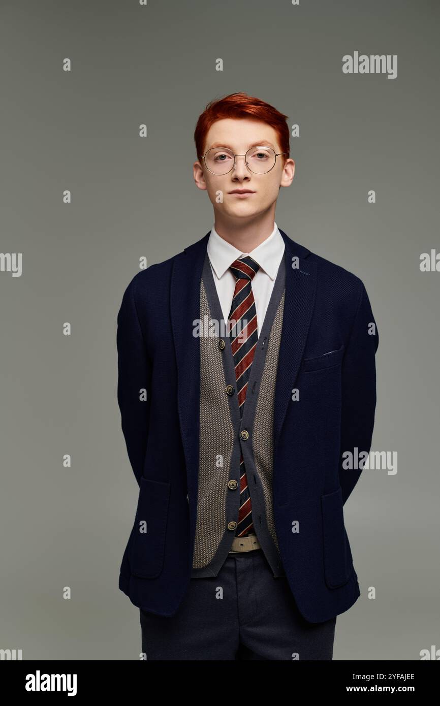 A handsome student showcases his red hair and layered winter outfit ...
