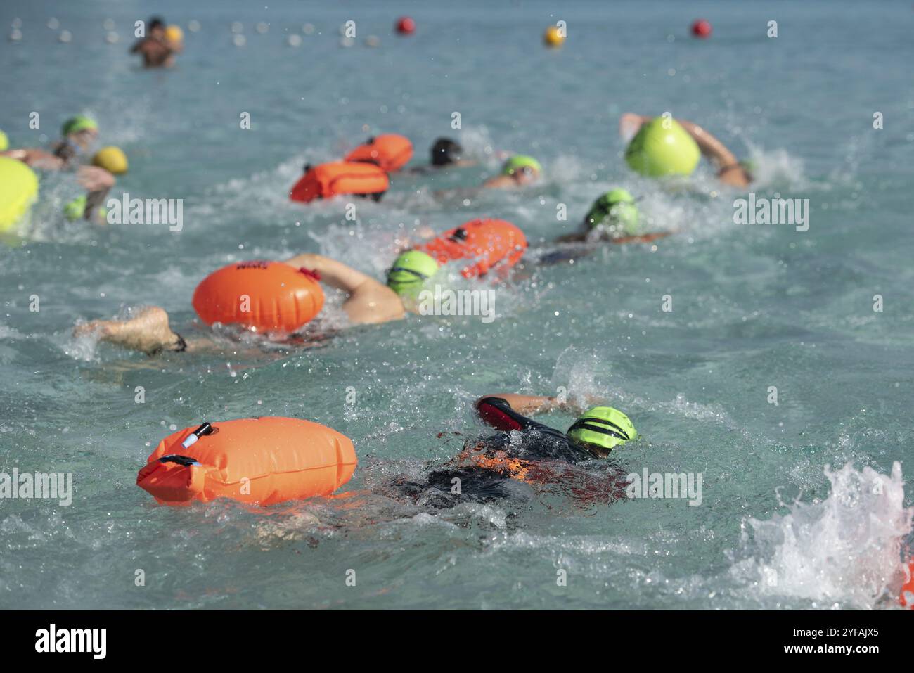 Athletes swimming free style in the sea during race competition ...