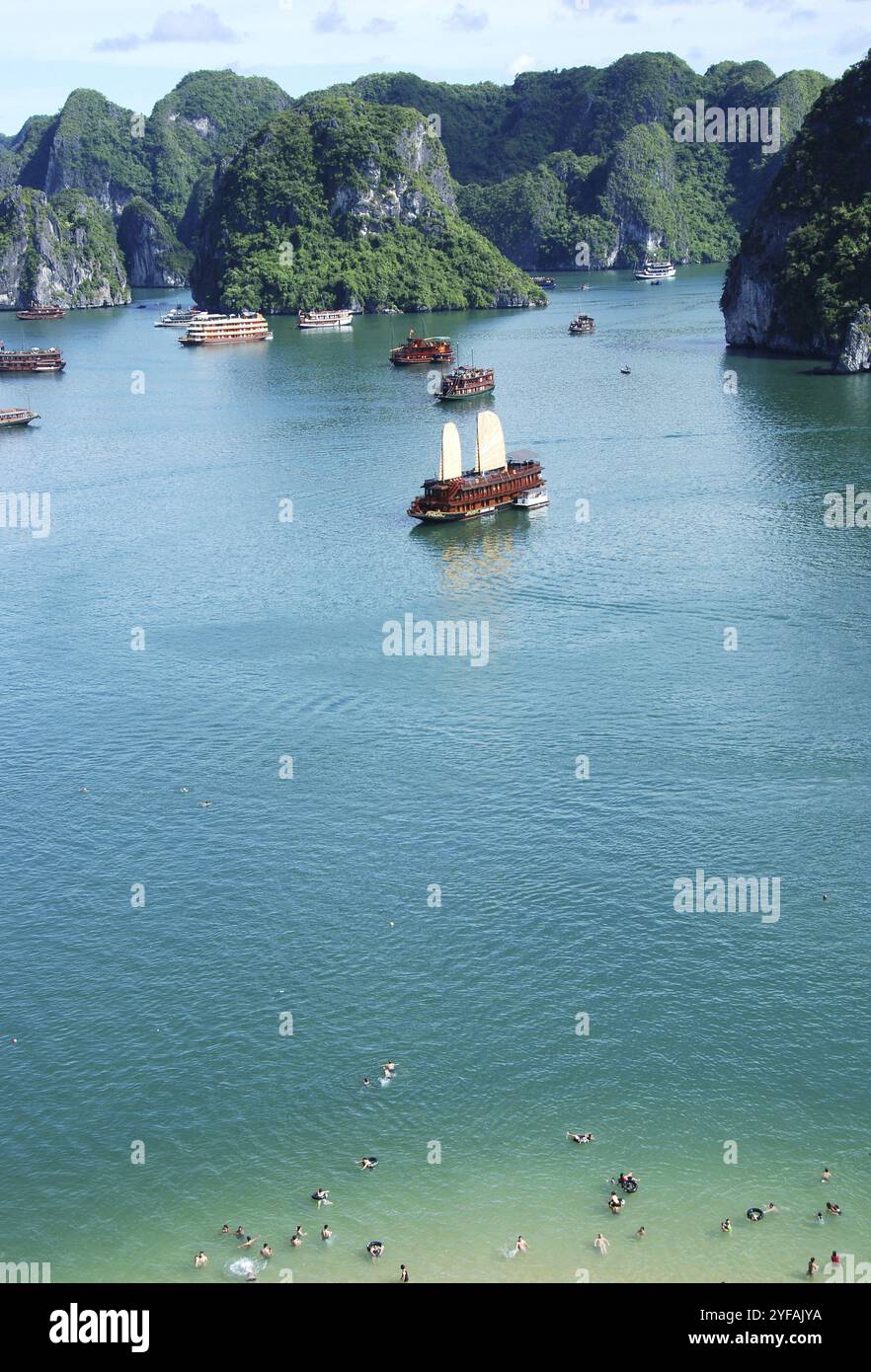 Halong Bay, Vietnam, August 5 2010: People swimming and wooden tourist ...