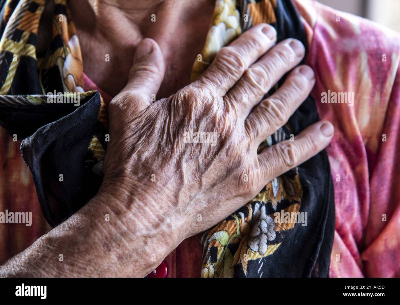 Wrinkled Hand of an elder woman with black clothing, wearing a wedding ...