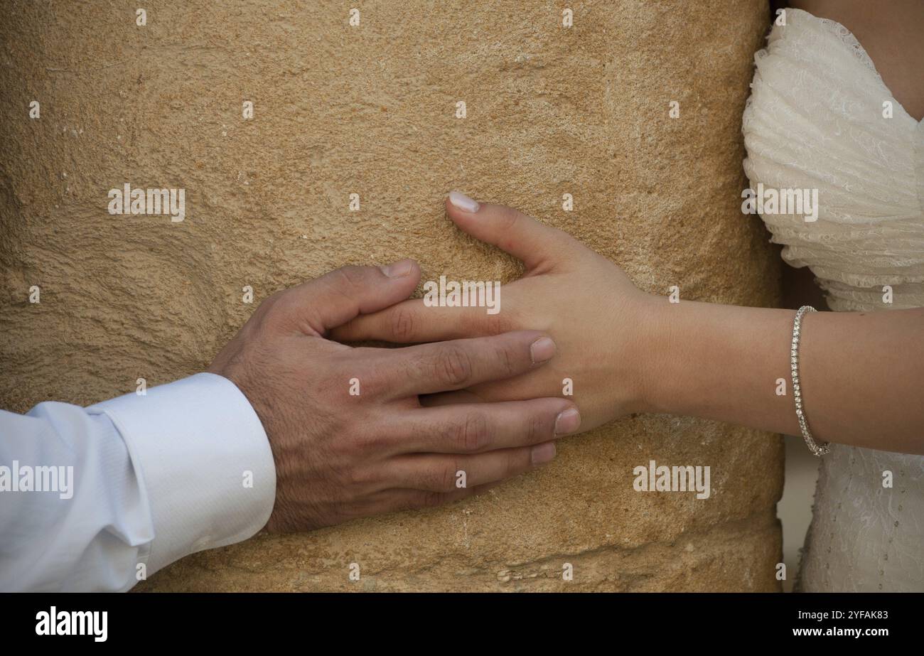 Groom and bride holding hands during wedding showing dedication to love ...