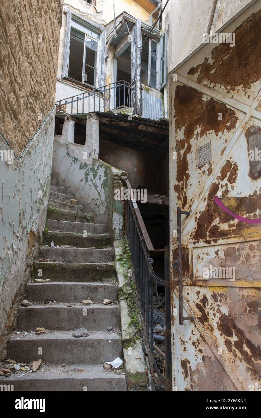 Damaged empty concrete stairs leading to an abandoned and collapsing ...