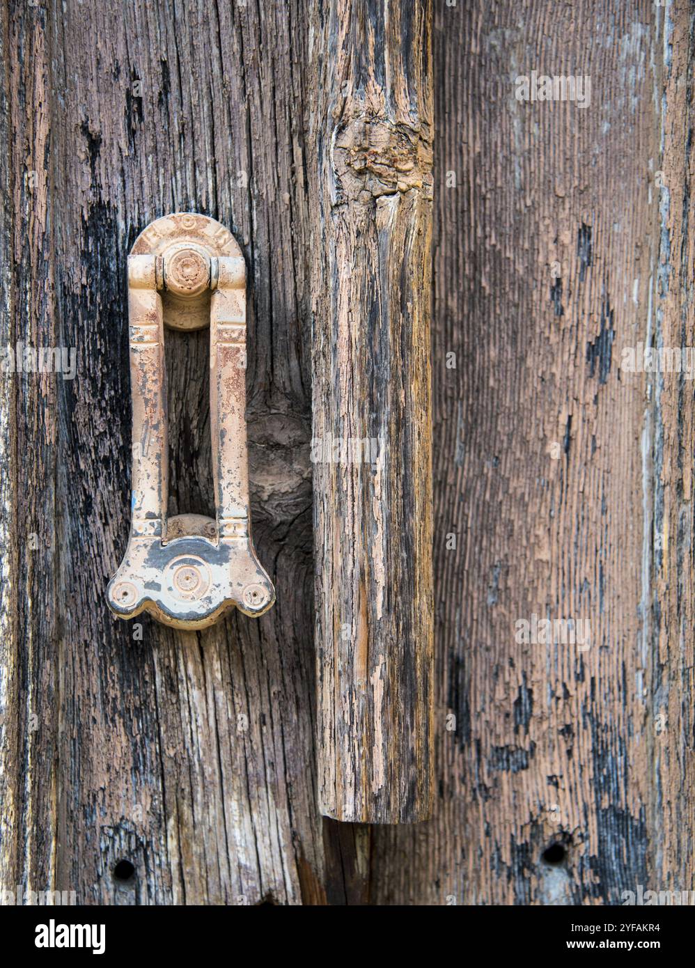 Metal vintage door handle on an old closed wooden rusty door Stock ...