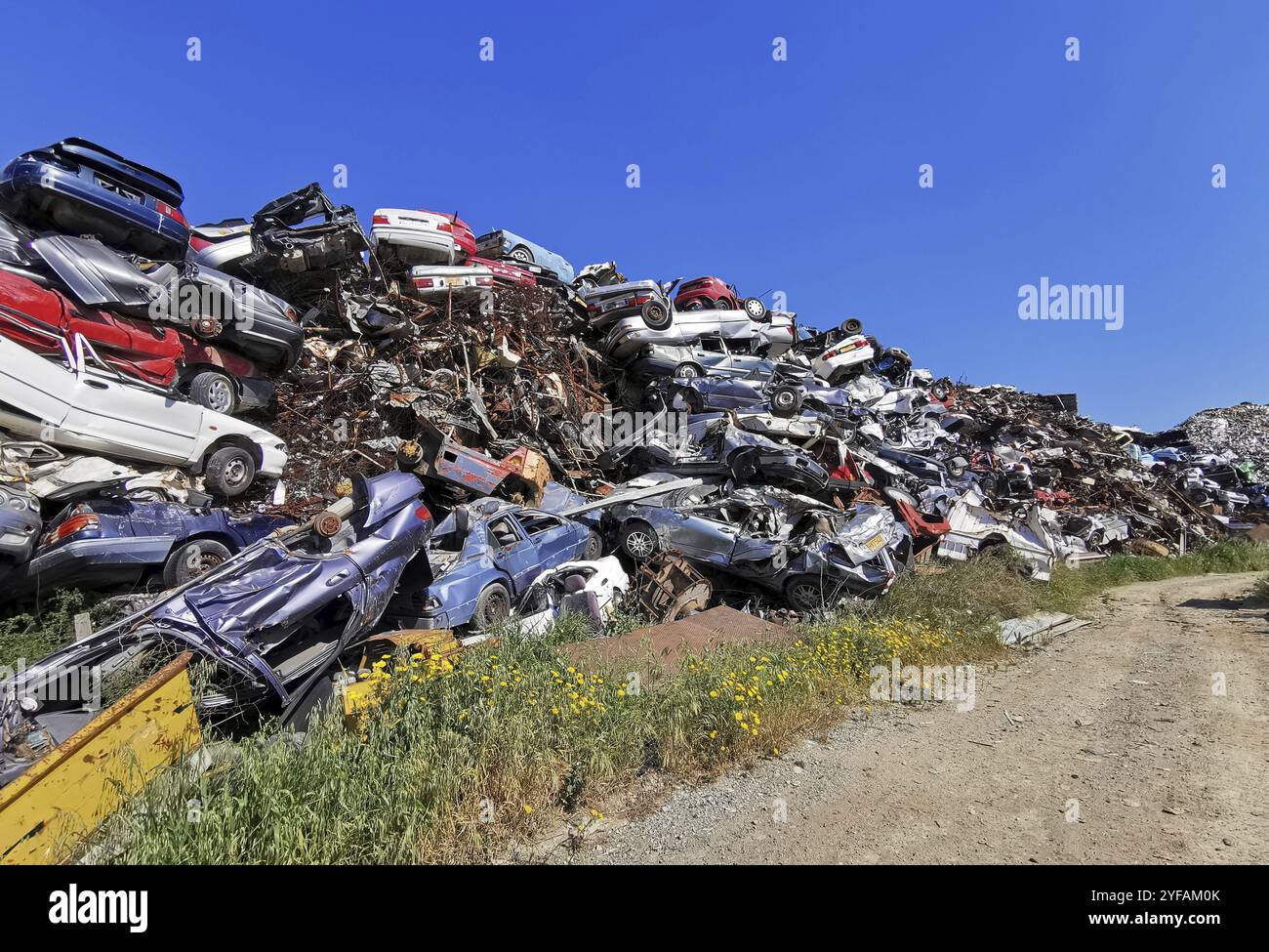 Pile of various scrap cars and other metals on a junk yard field ready ...